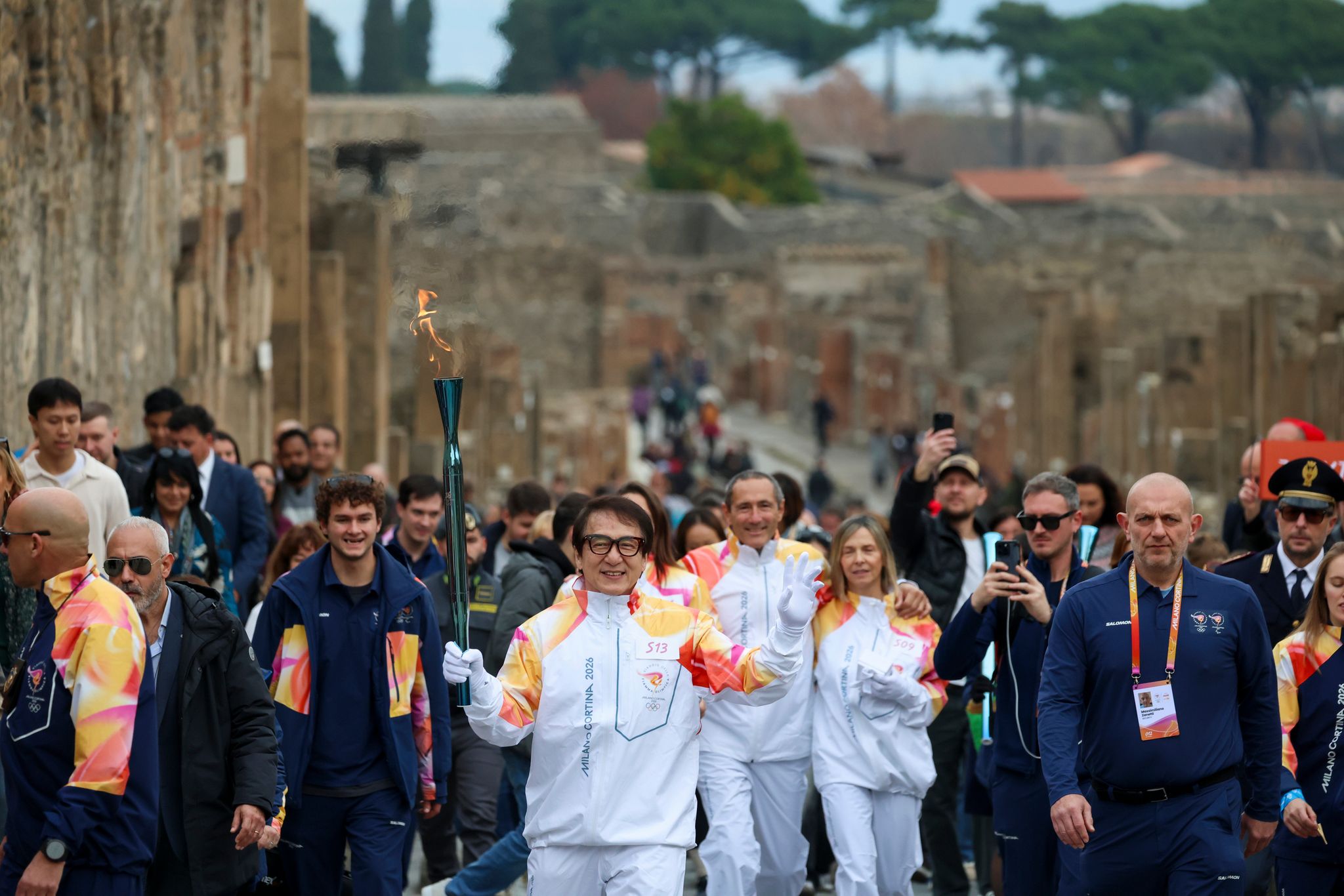 Jackie Chan carries the Milan Cortina Olympic torch through the ruins of Pompeii