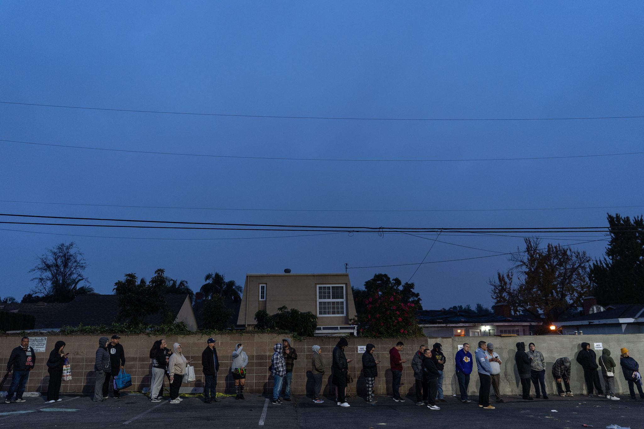 Families wait in line for hours to buy masa for Christmas tamales at ...