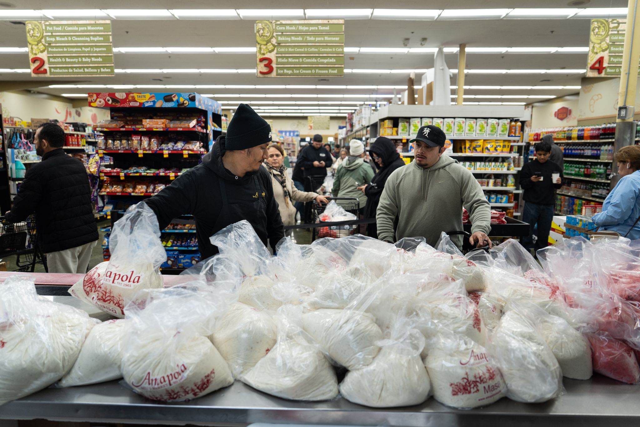 Families wait in line for hours to buy masa for Christmas tamales at ...