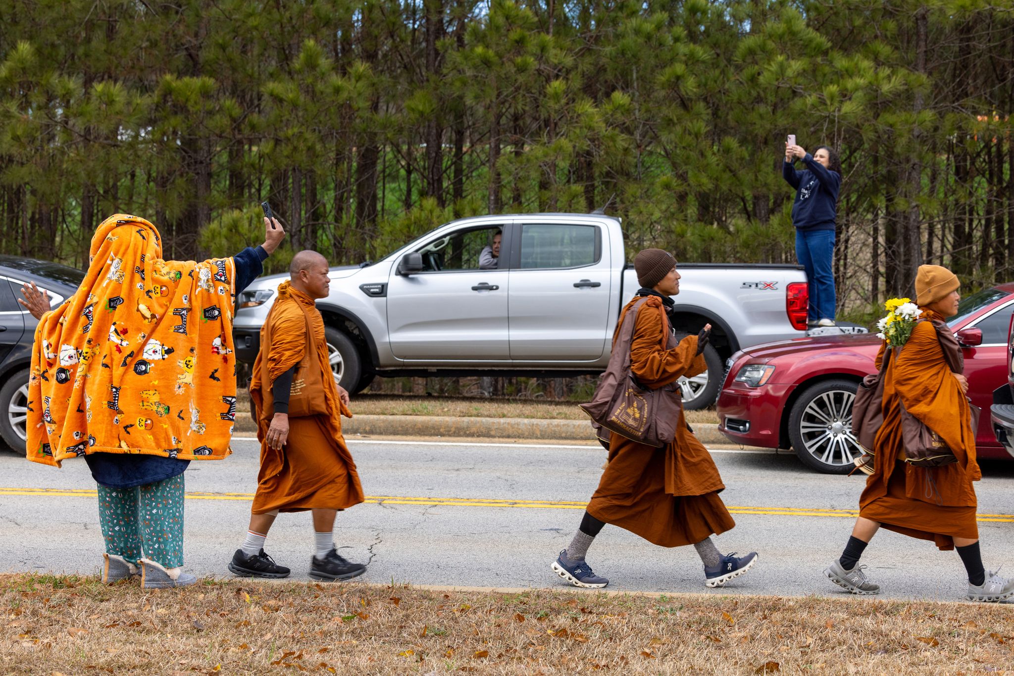 Buddhist monks persist in peace walk despite injuries as thousands ...