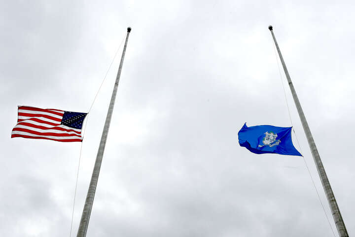 Why do the U.S., CT flags sometimes fly at half-staff?
