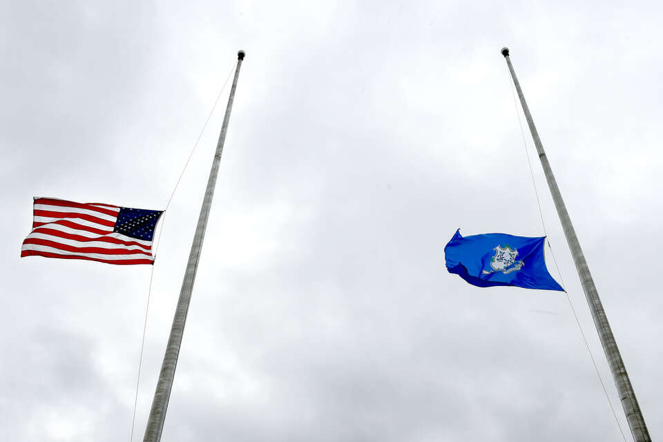 Why do the U.S., CT flags sometimes fly at half-staff?