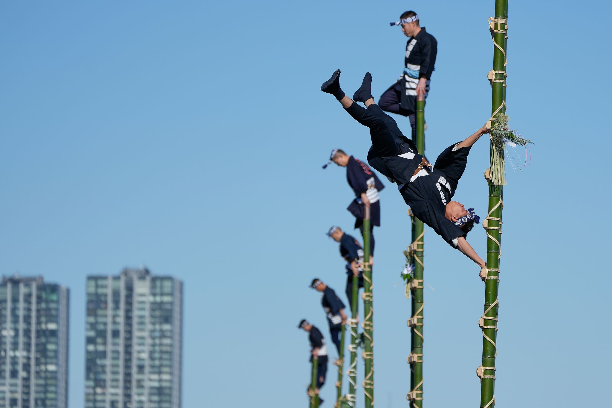 Photos show ladder stunts and other activities at a Tokyo fire brigade ...