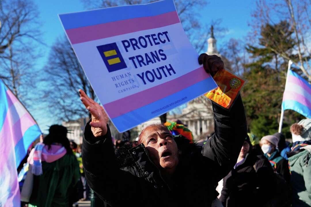 Photos of demonstrators outside the Supreme Court as it considers ...