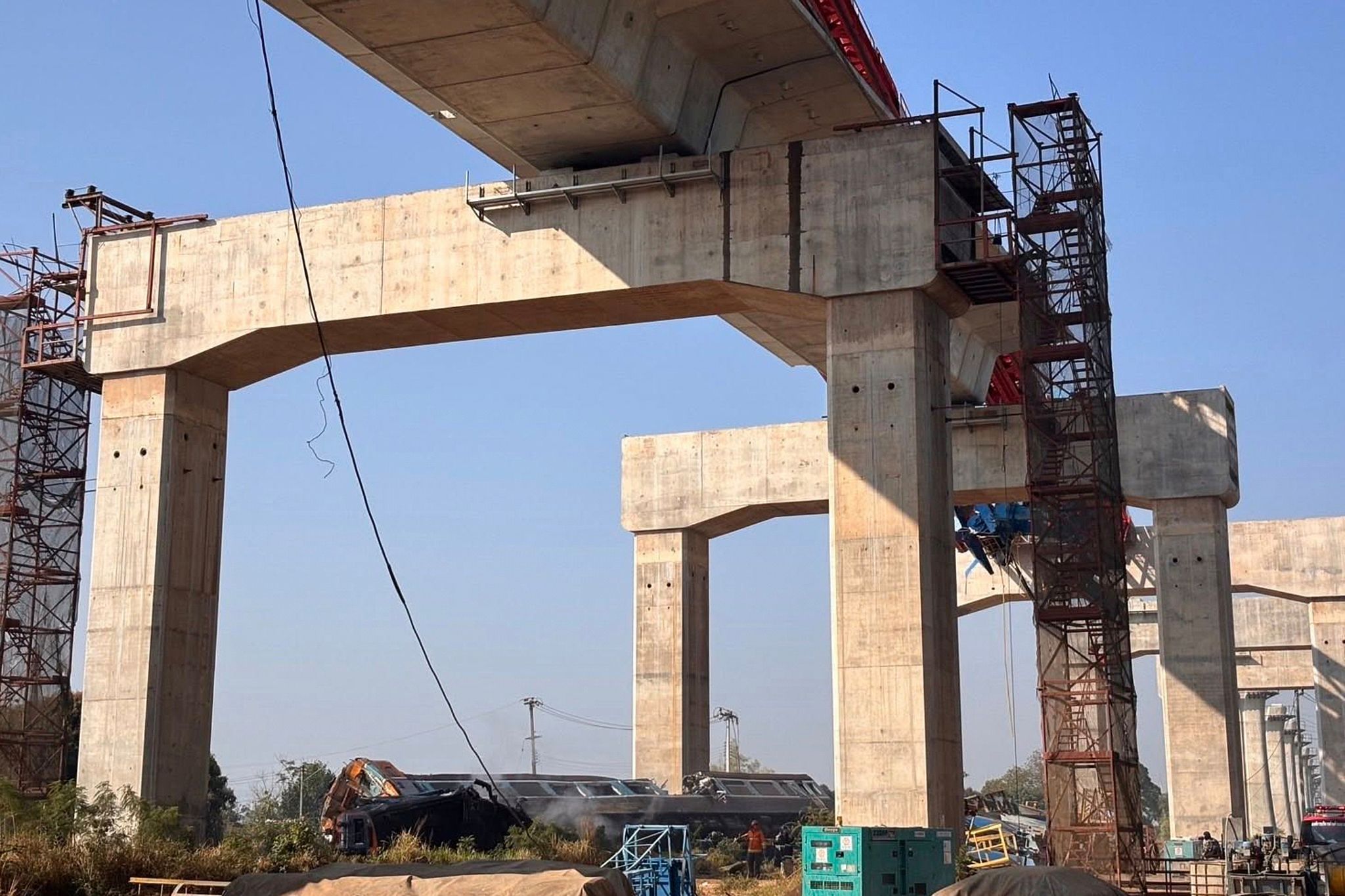 A construction crane falls on a passenger train in northeastern ...