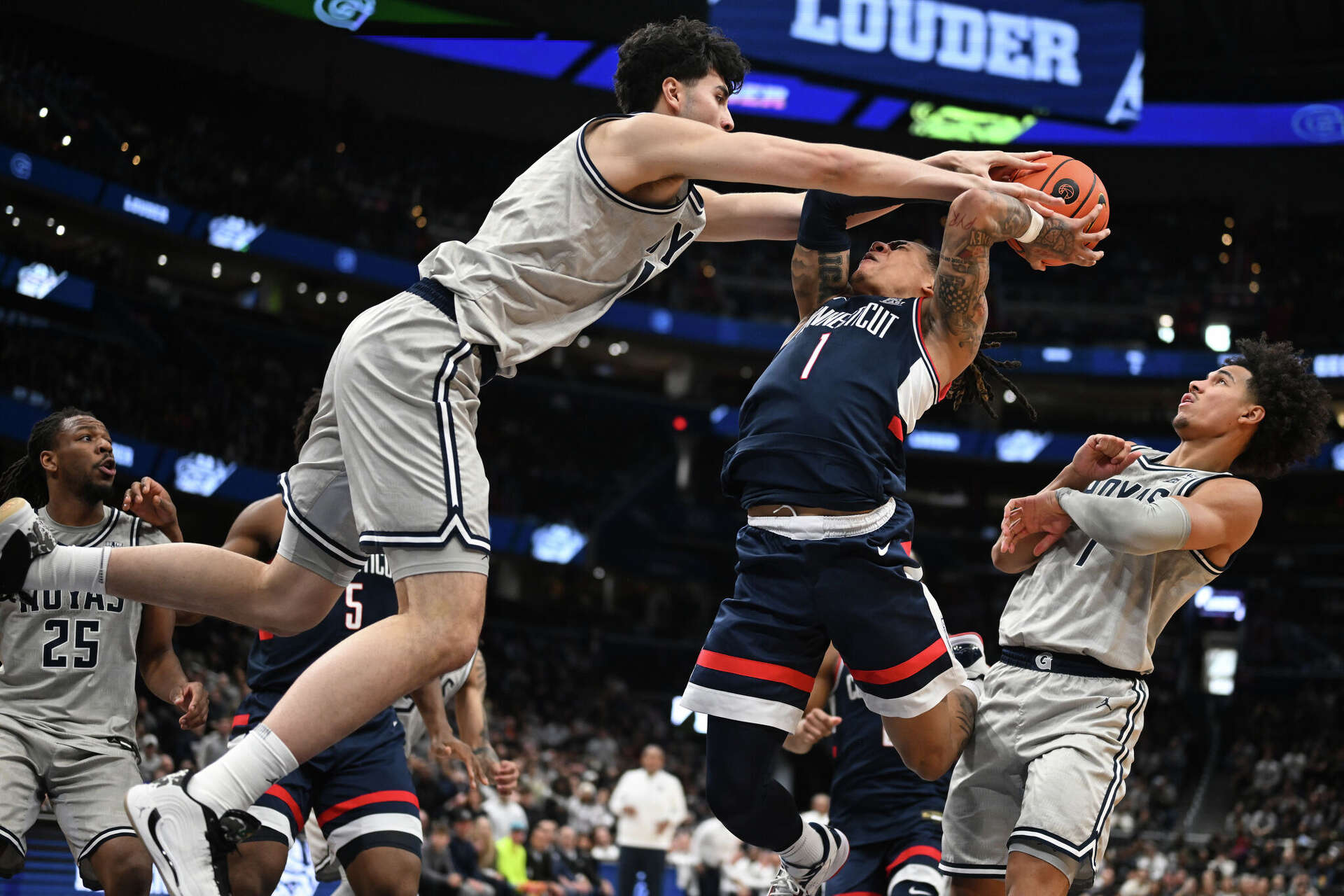 UConn men's basketball survives poor foul shooting, edges Georgetown.