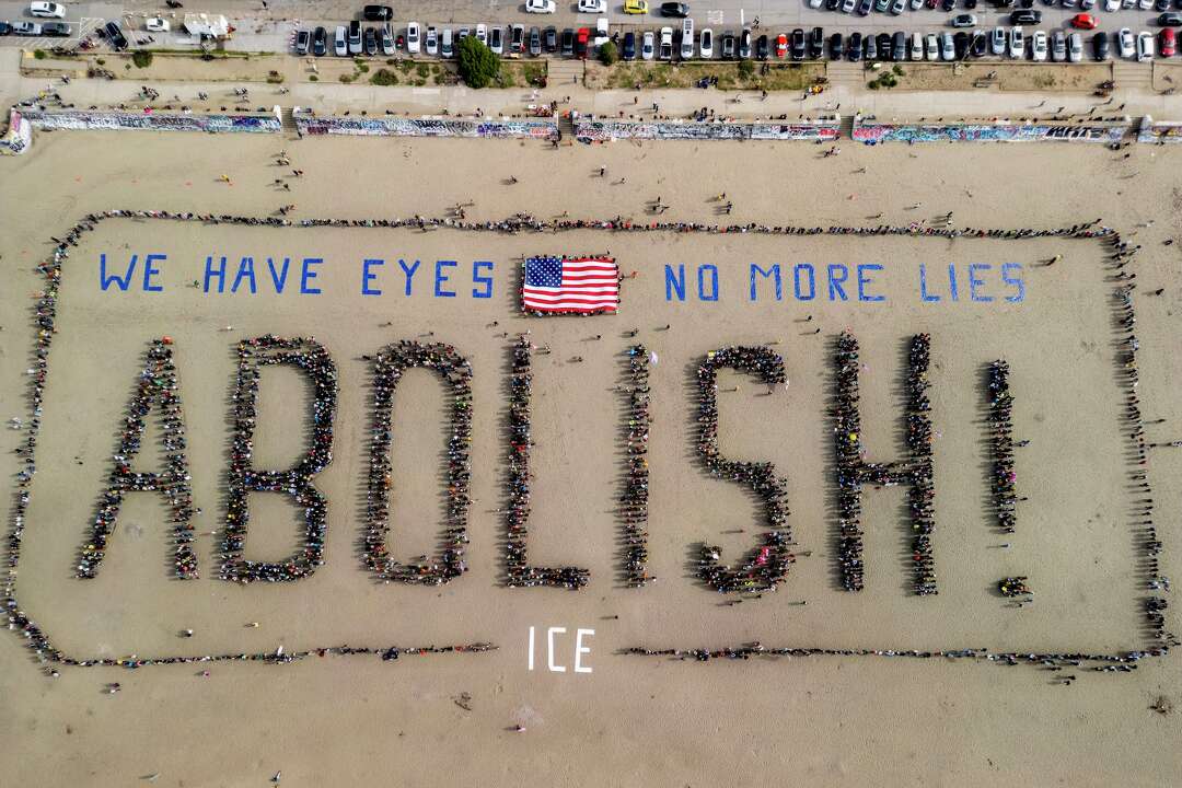 Photos: Thousands of SF protesters form banner with message for ICE