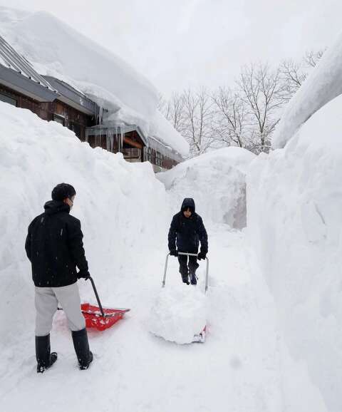 Heavy snow in northern Japan blocks roads and causes dozens of deaths