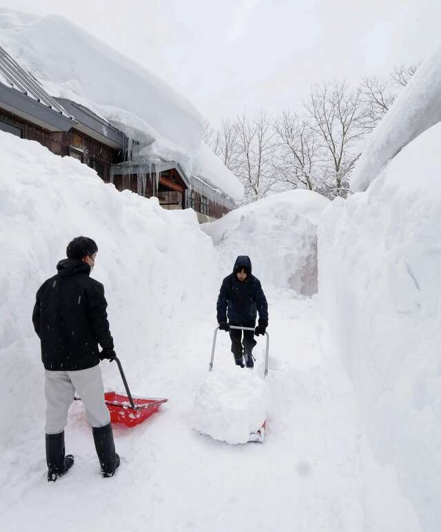 Heavy snow in northern Japan blocks roads and causes dozens of deaths