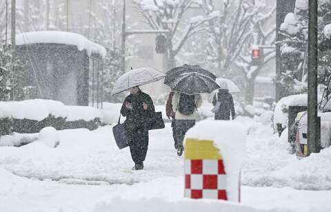 Heavy snow in northern Japan blocks roads and causes dozens of deaths