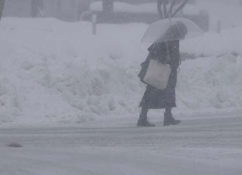 Heavy snow in northern Japan blocks roads and causes dozens of deaths