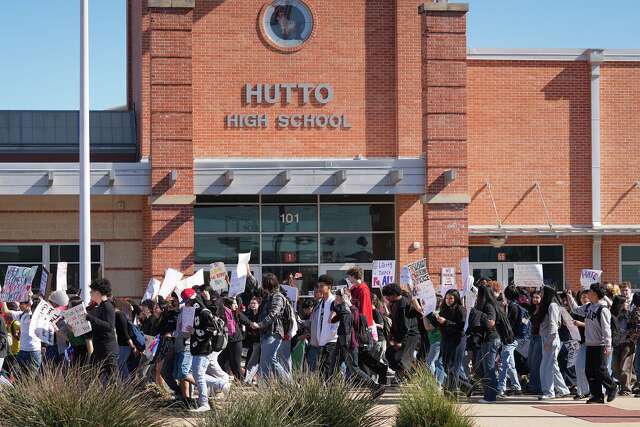 Students protest ICE at Hutto High School, see photos from walkout