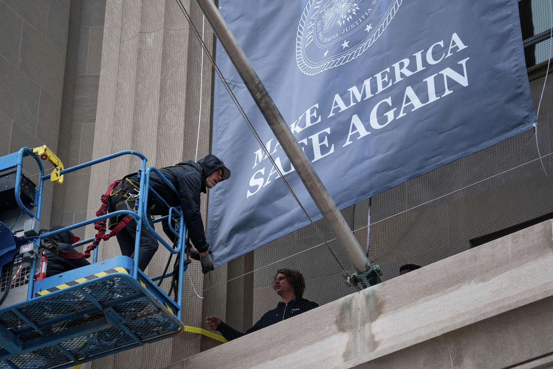 Large banner featuring Trump's face is displayed on Justice Department ...