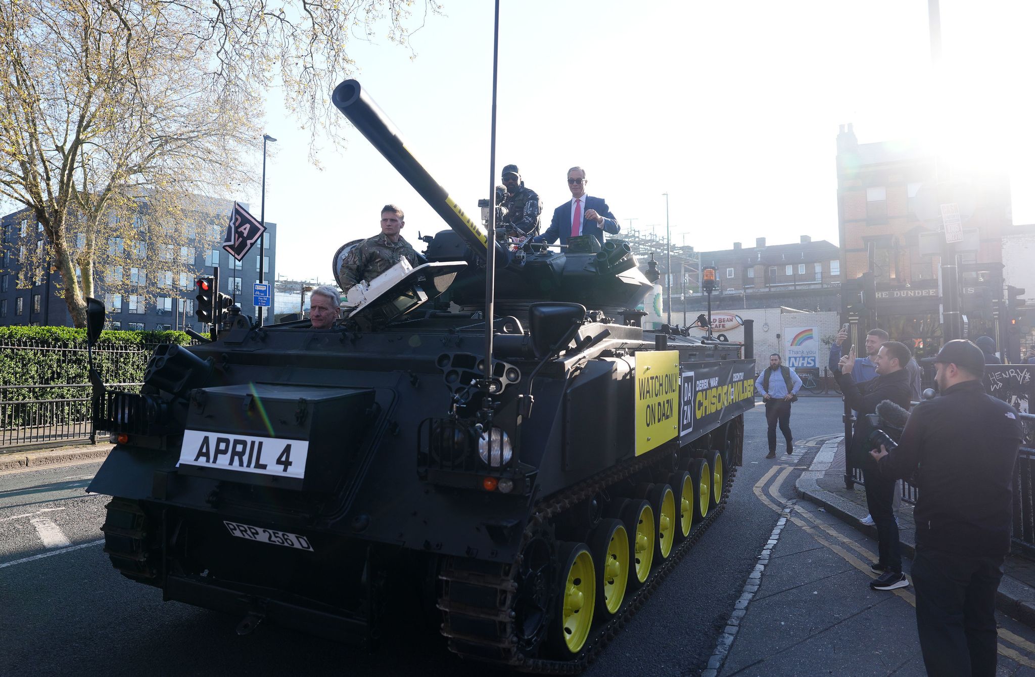 Heavyweight boxer Derek Chisora rides army tank with Nigel Farage to ...