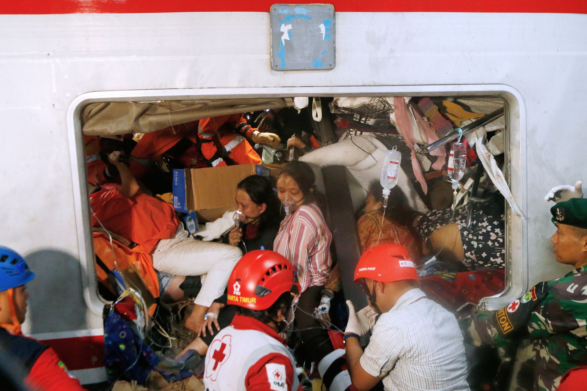 Rescuers recover victims from an Indonesia train crash, in photos