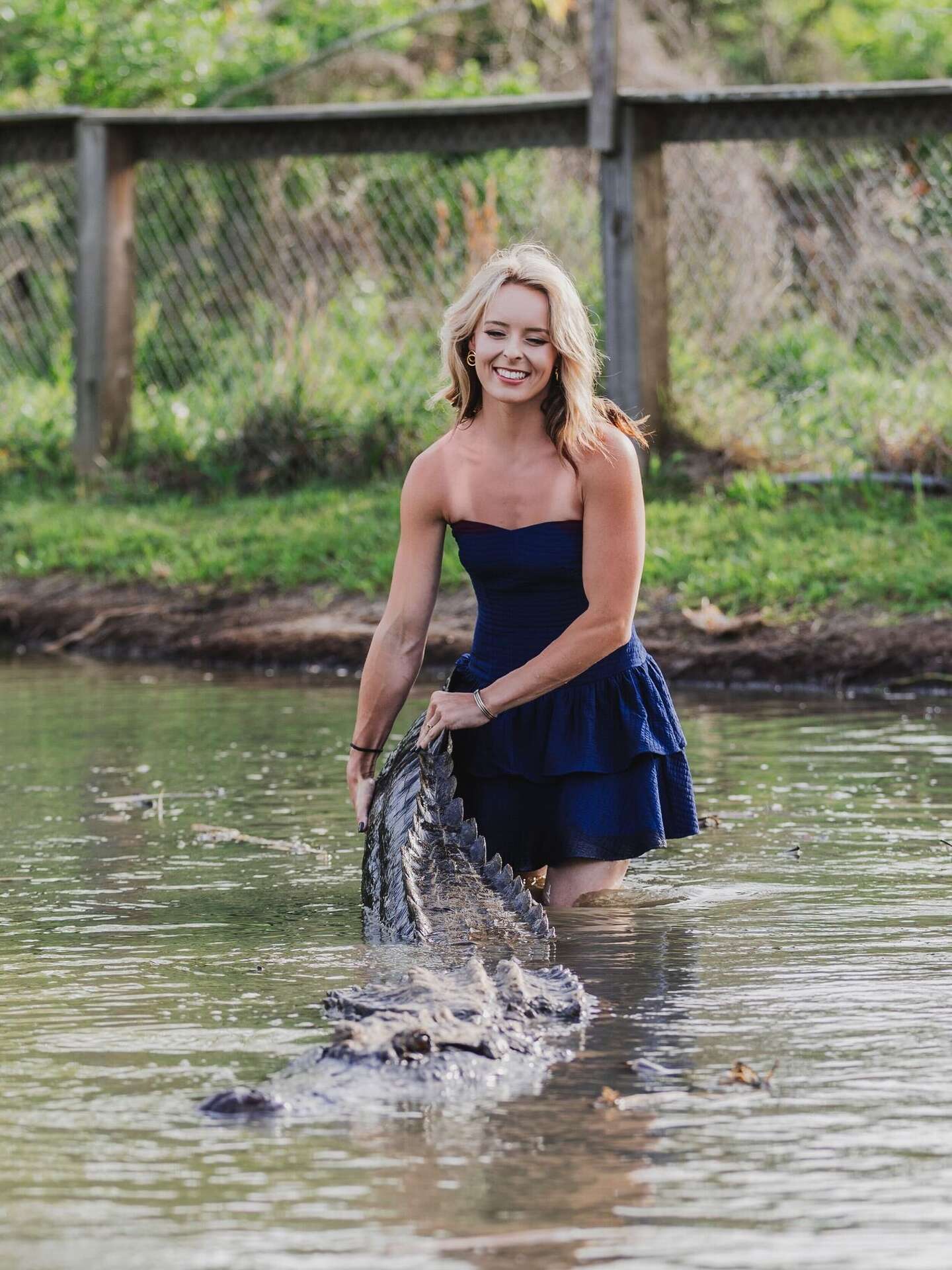 Gator Country staffer's grad photos show kiss with giant alligator