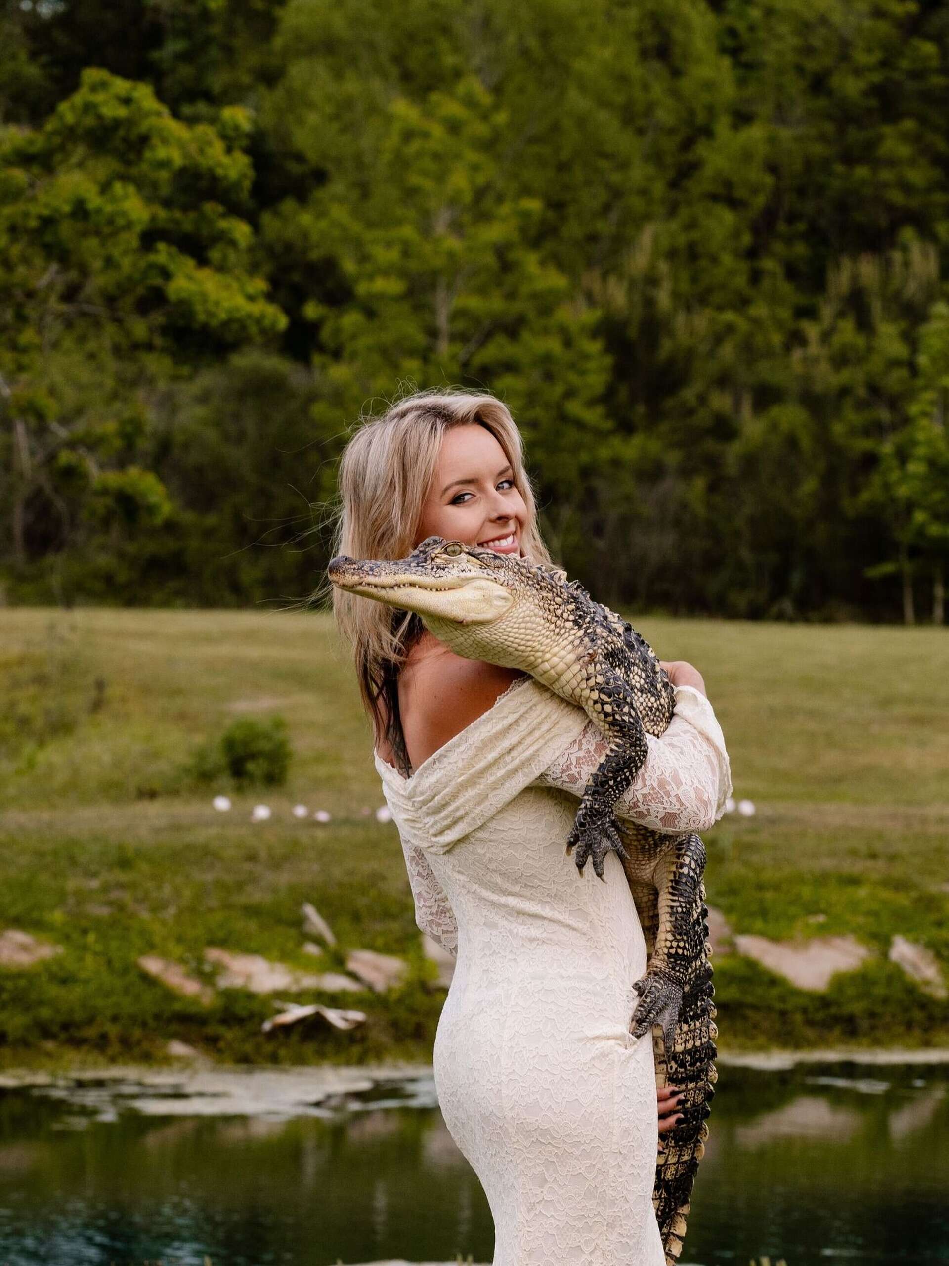 Gator Country staffer's grad photos show kiss with giant alligator