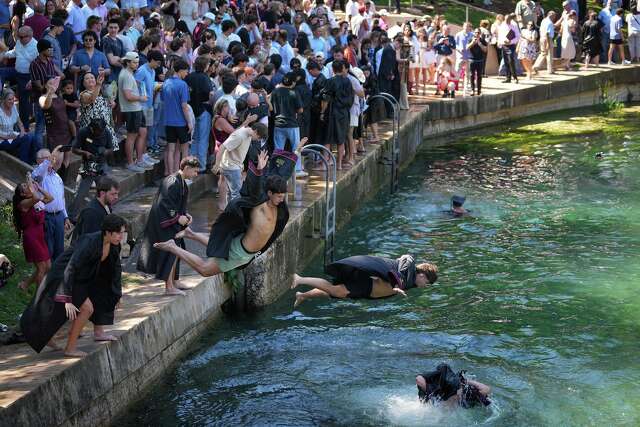 Texas State graduates jump into San Marcos River after commencement