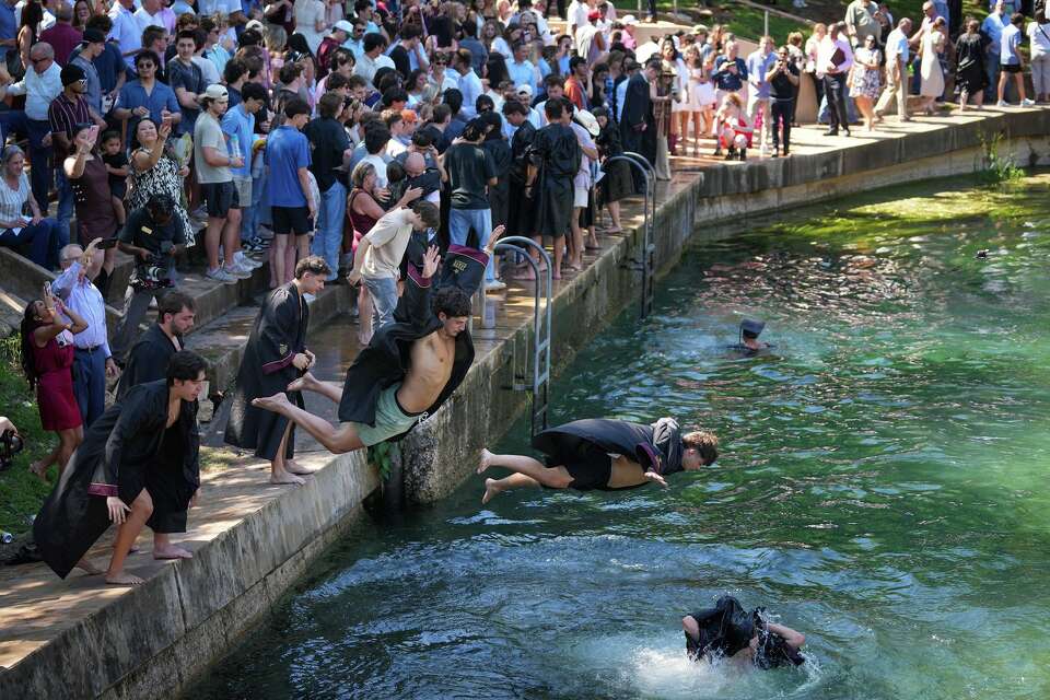 Texas State graduates jump into San Marcos River after commencement