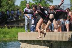 Texas State graduates jump into San Marcos River after commencement