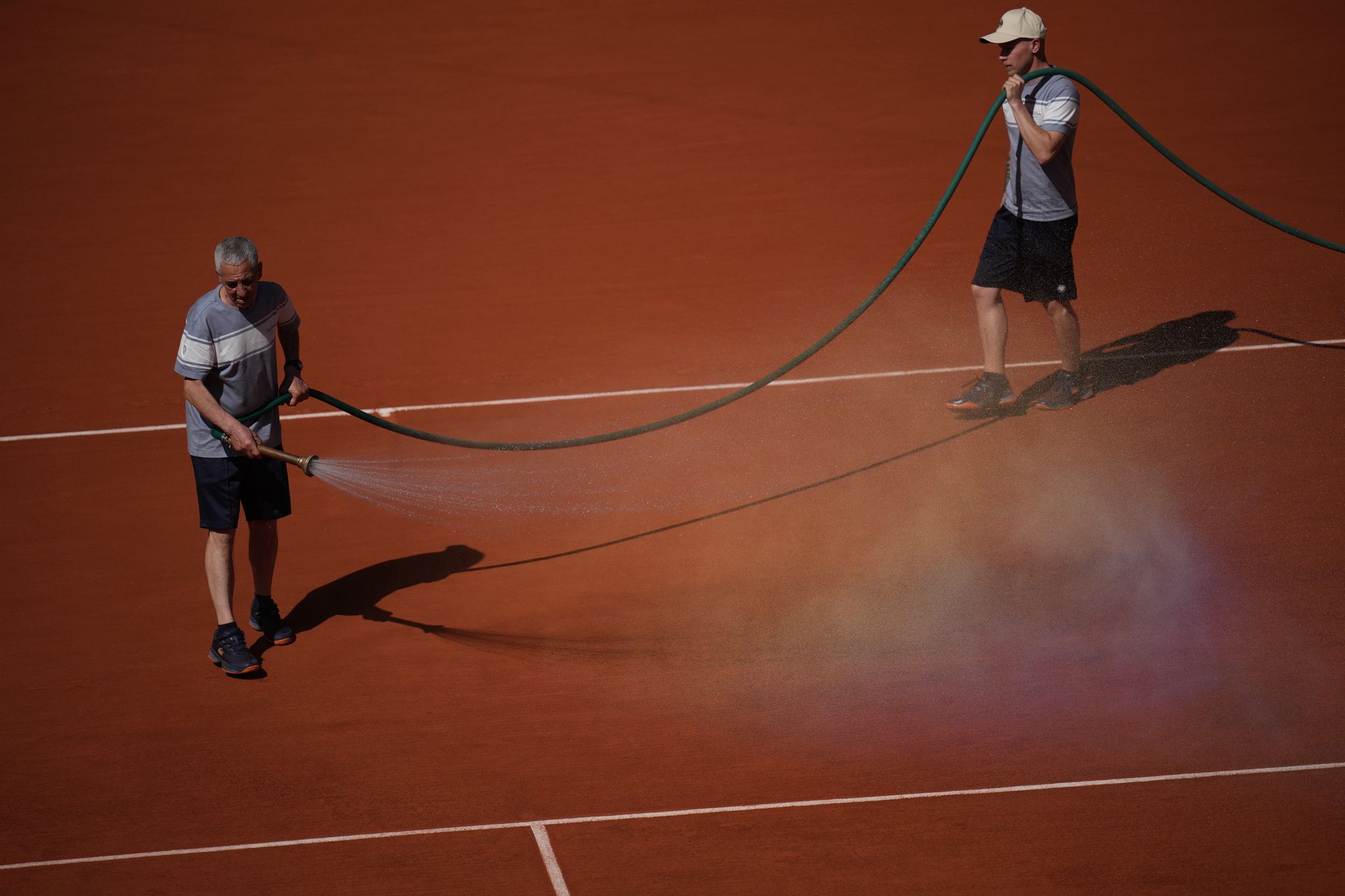 French Open groundskeepers drench the clay courts with water and salt ...