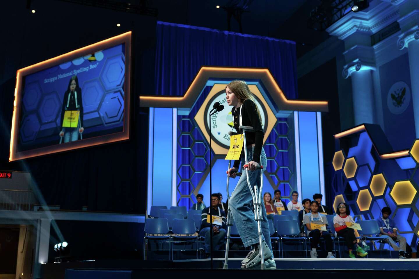 Photos of students competing for the Scripps National Spelling Bee trophy