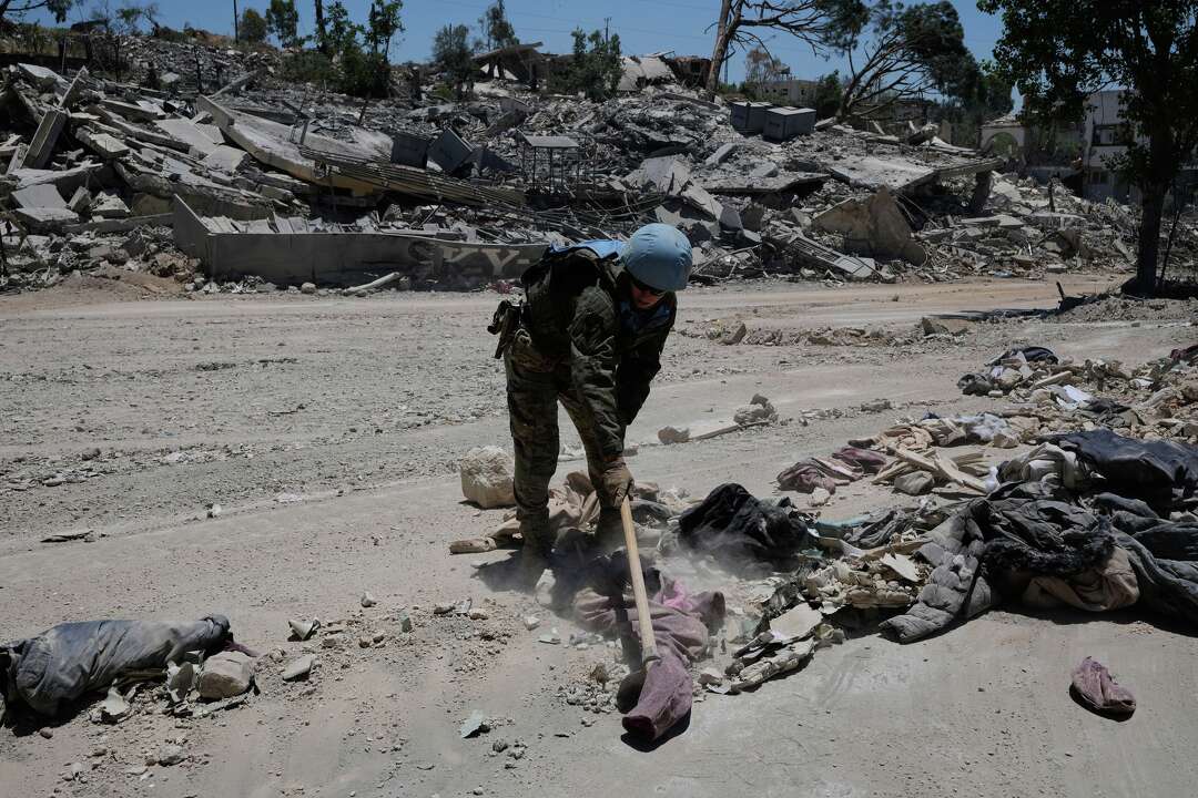 Photos show Lebanese and UN troops take positions in a village vacated ...