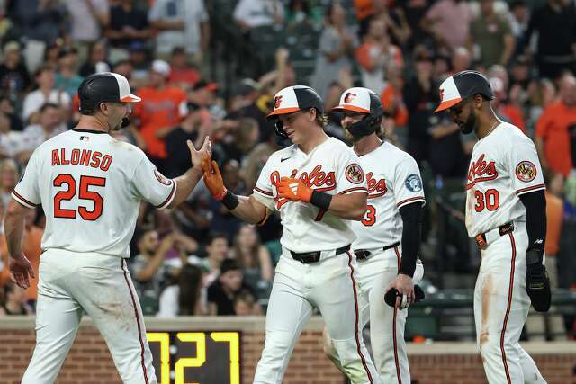 Holliday hits grand slam and Young pitches Orioles past Mariners 7-2 to ...