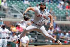 Ray dominant in relief as Giants complete 7-2 win over Braves in Game 1 ...
