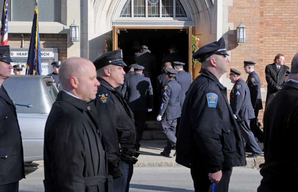 Police salute a fallen officer
