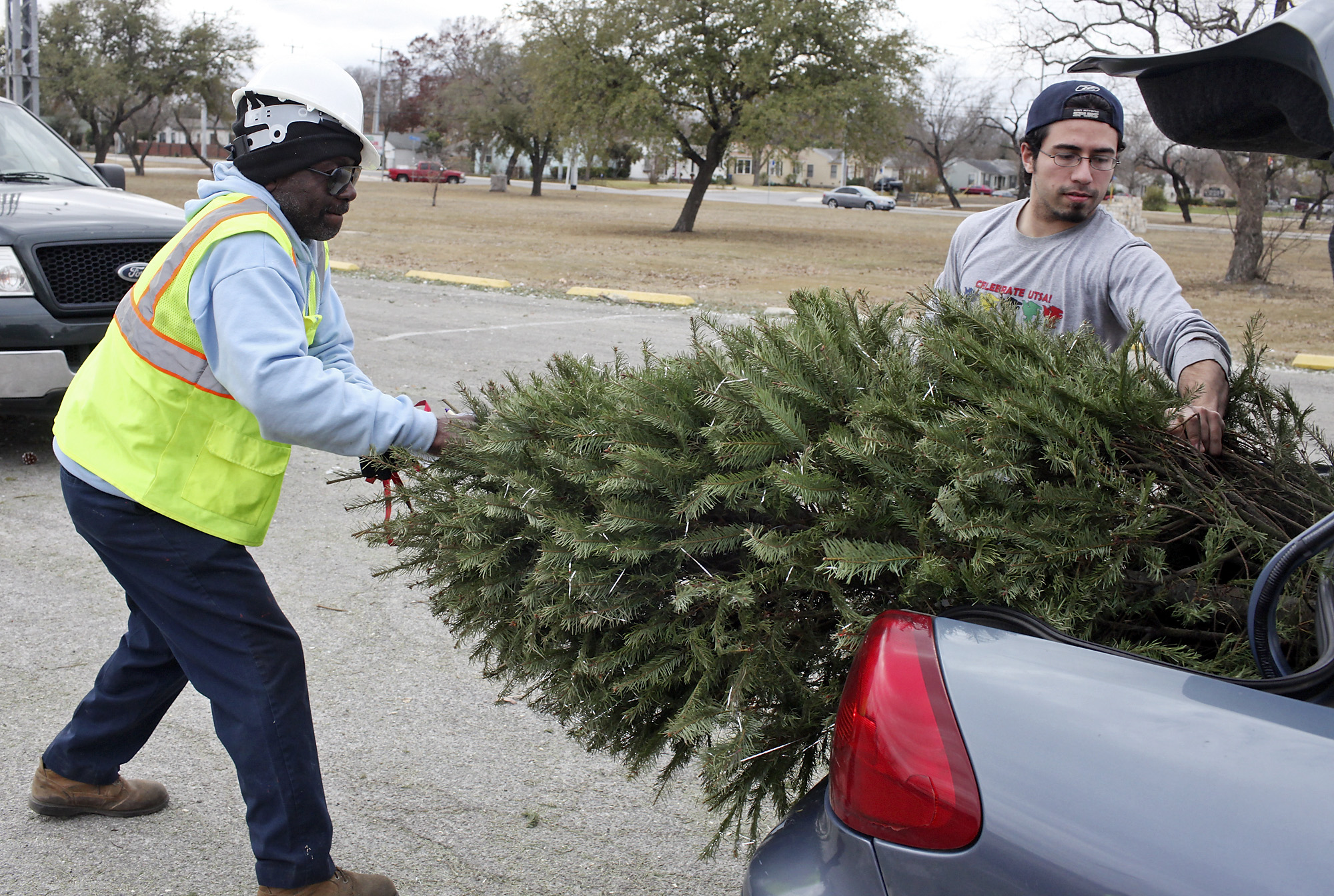 Residents drop off Christmas trees at city recycling sites