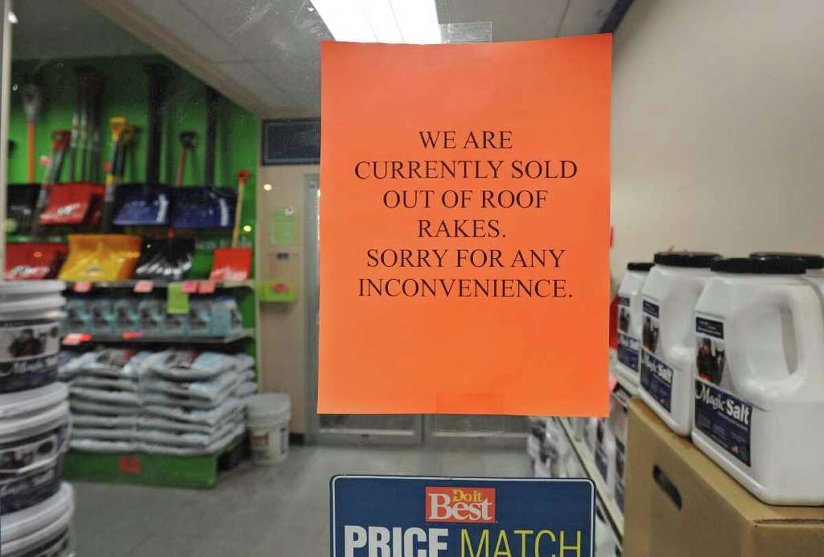 Roof rakes a commodity as snow piles up