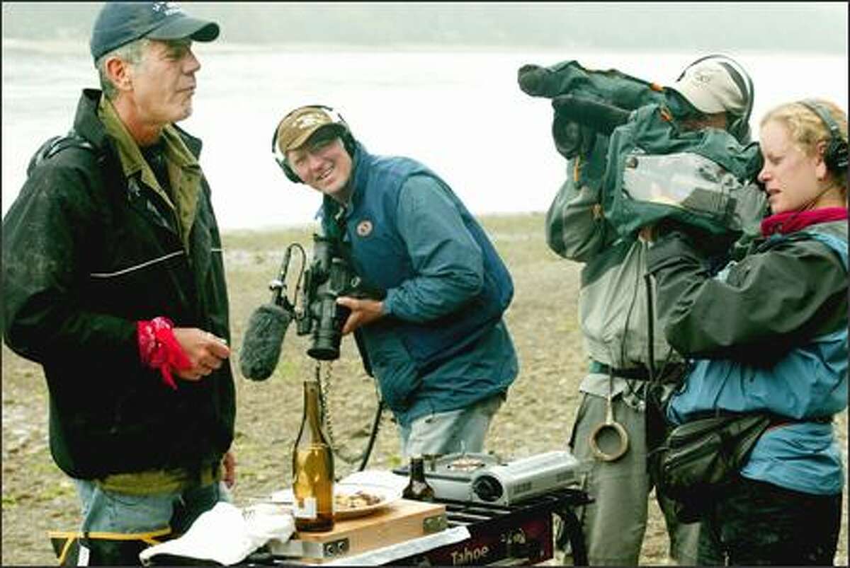 Chef Bourdain's crew has no reservations about geoduck hunt in the muck