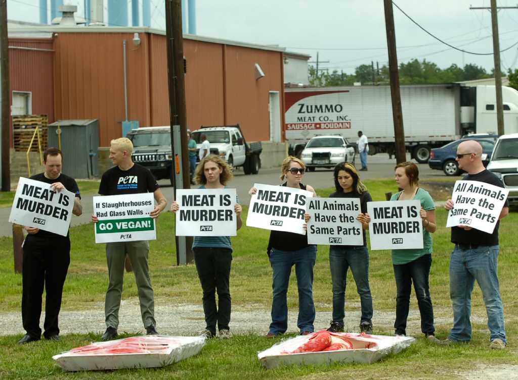 PETA protesters model themselves as meat in front of local sausage factory