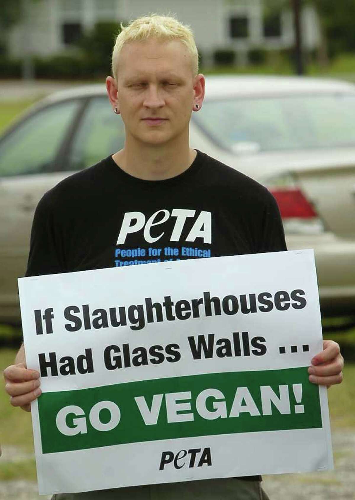 PETA protesters model themselves as meat in front of local sausage factory