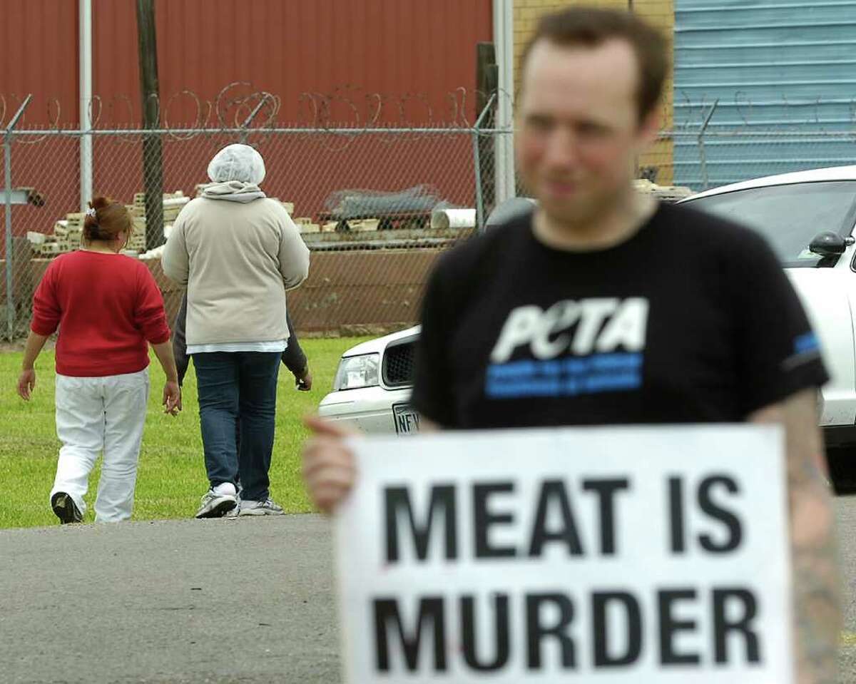PETA protesters model themselves as meat in front of local sausage factory