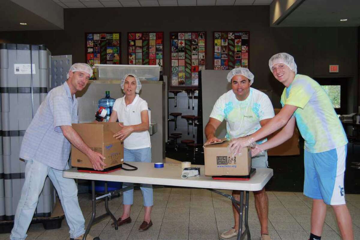 New Canaan's Pura Vida for Children packs food for starving children