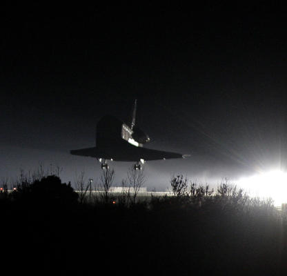Space shuttle makes rare nighttime landing