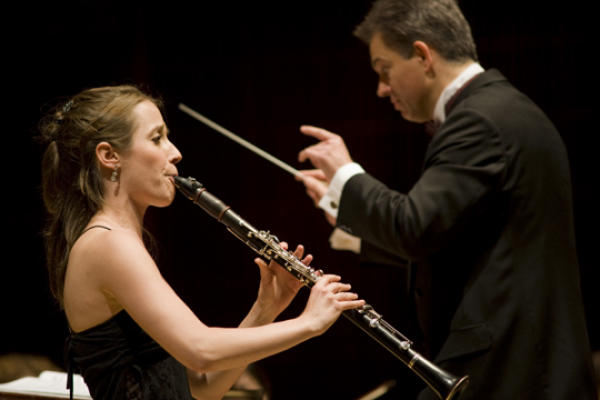 A clarinetist takes her bows