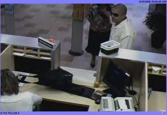 FBI seeks robber who held bank teller hostage