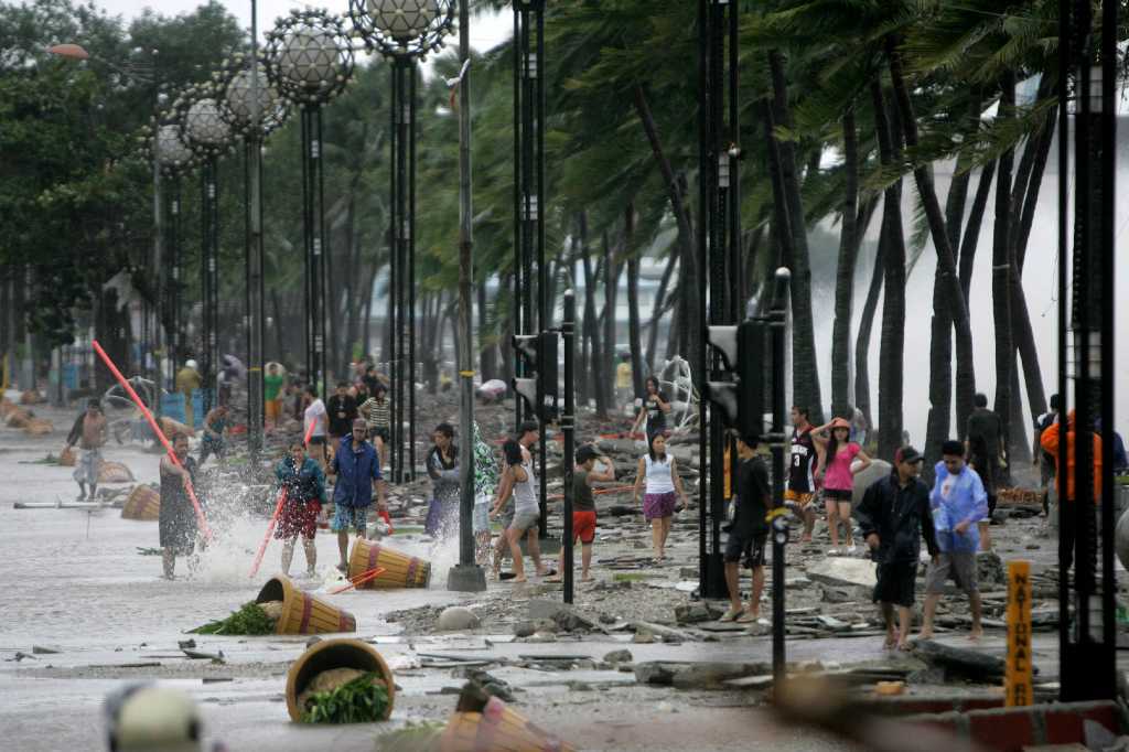 Manila cleans up after typhoon rains kill 18