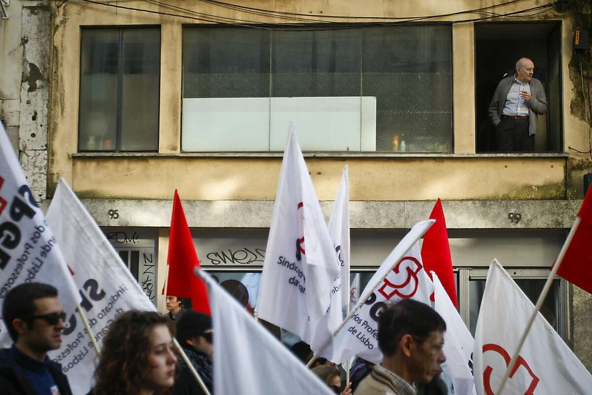 Portugal hit by downgrade to junk status, strike