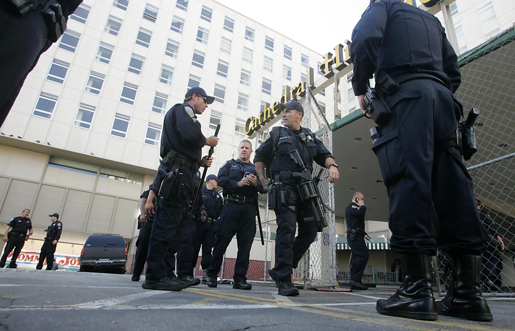 Activists scatter before police raid vacant hotels