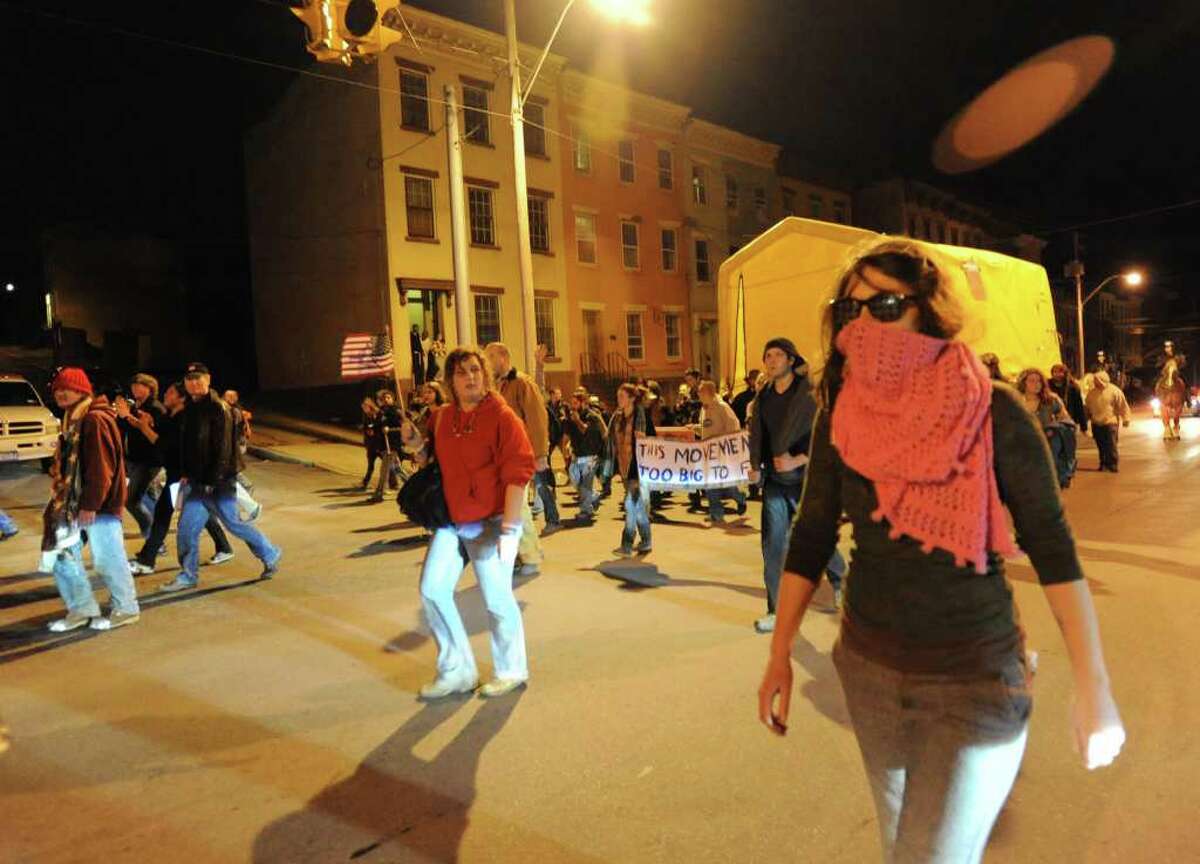 Protesters, police tussle as tents fall