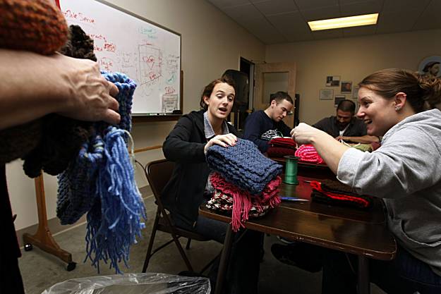 Volunteers knitting thousands of scarves for needy