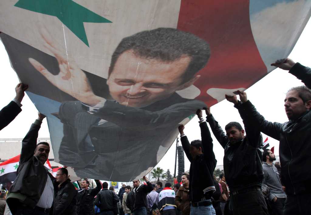 Assad makes surprise appearance; journalist killed