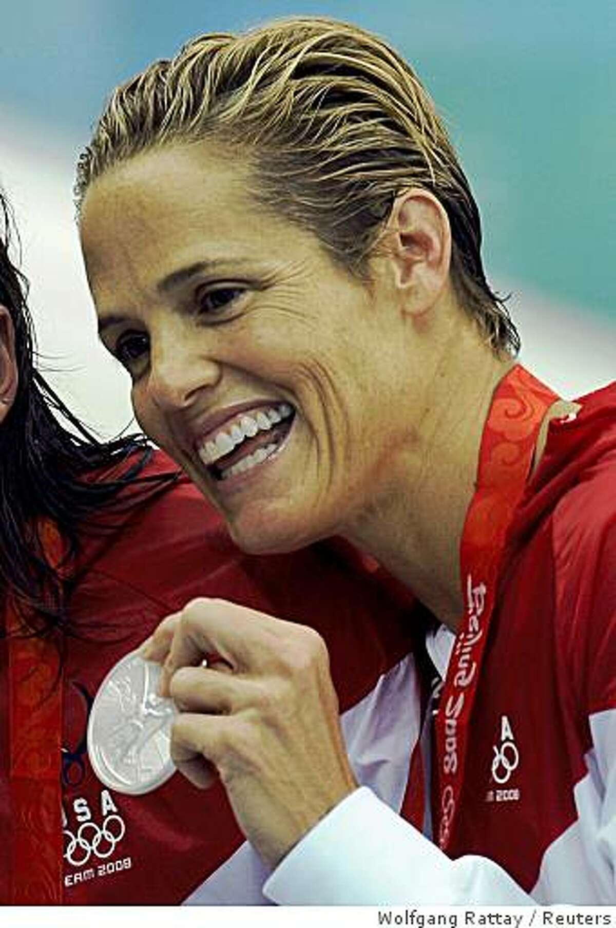 Teammates help Torres pick up 10th medal