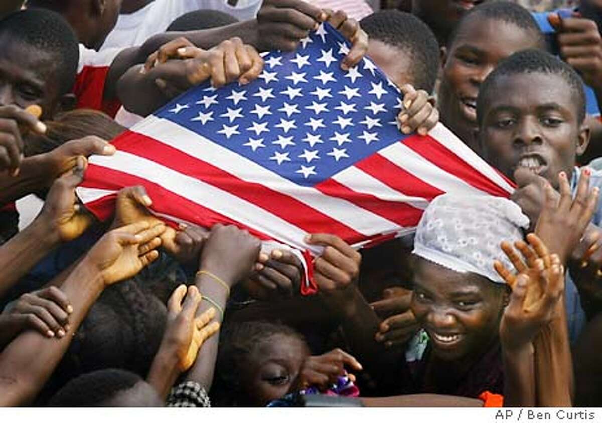 Liberians cheer arrival of U.S. team in Monrovia / War-weary citizens ...