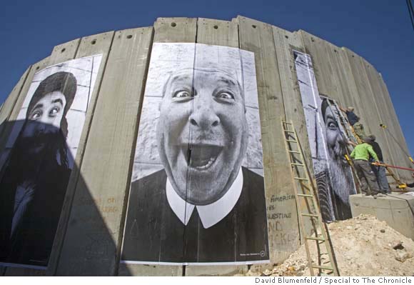 A troubled region shows its funny face / Giant portraits' goal to erode ...