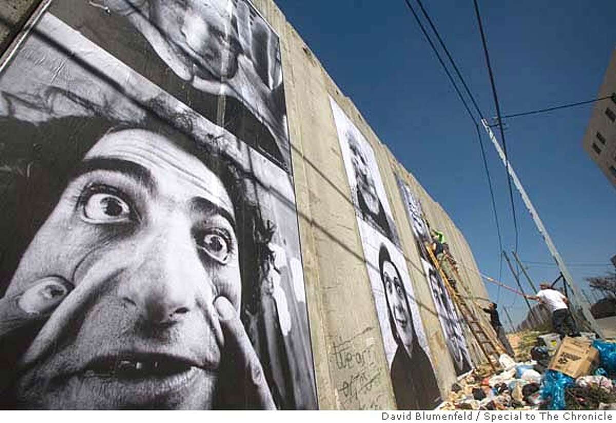 A troubled region shows its funny face / Giant portraits' goal to erode ...